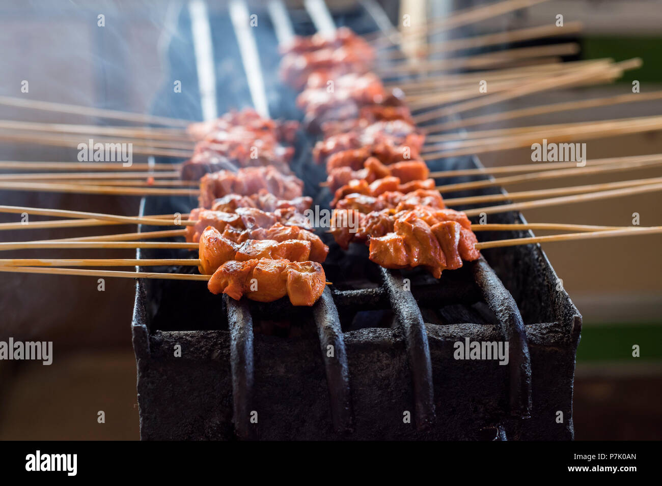 Meat skewers on a traditional charcoal grill in Indonesia Stock Photo ...