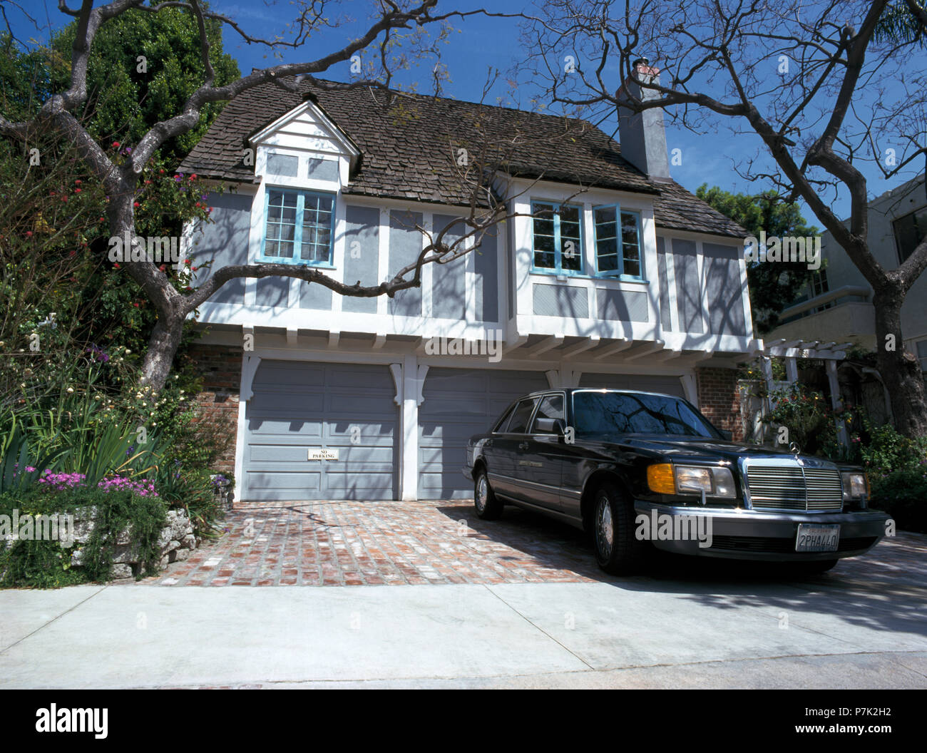 American car on drive in front of garages Stock Photo - Alamy