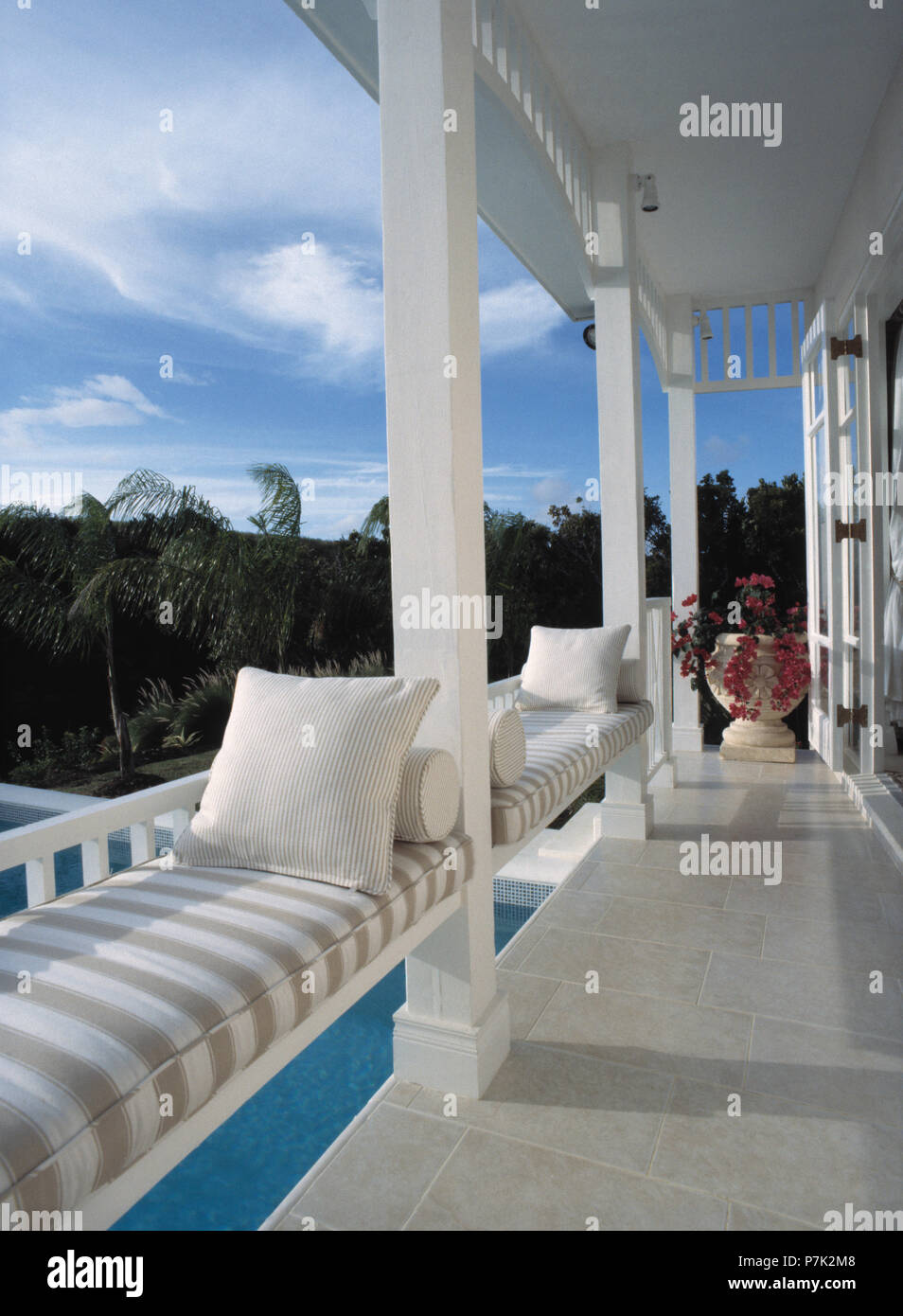 Striped cushions on seats on veranda of Caribbean house Stock Photo - Alamy