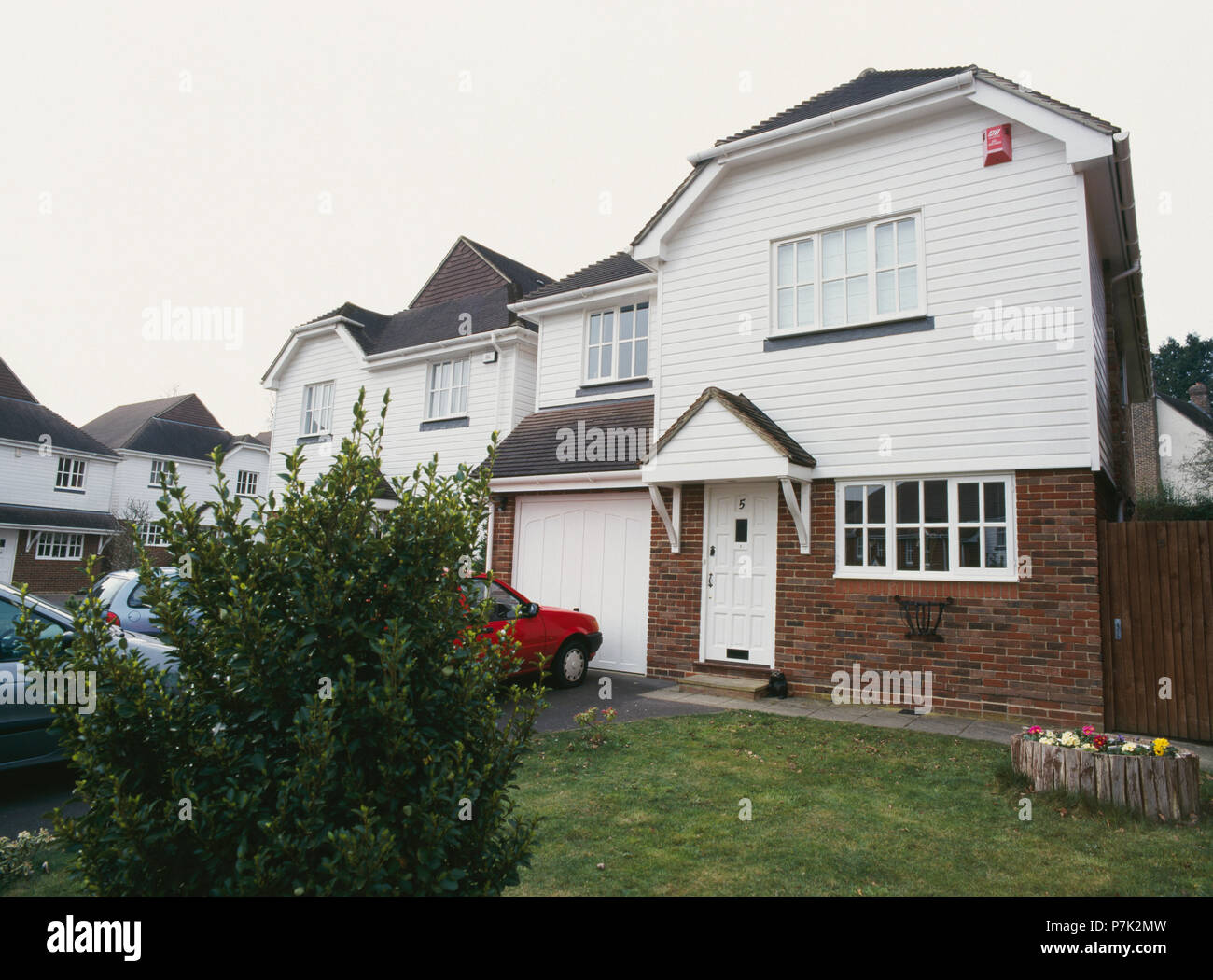 New-build house with white wood cladding Stock Photo - Alamy