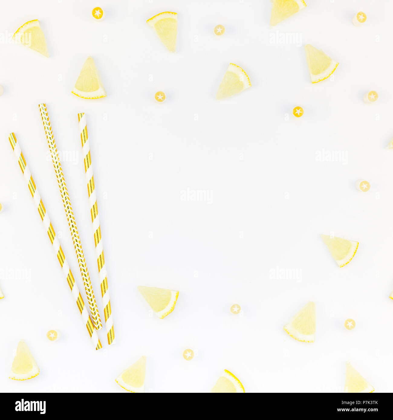 Square flatlay overhead top view citrus lemon slices pattern frame white table background with ...