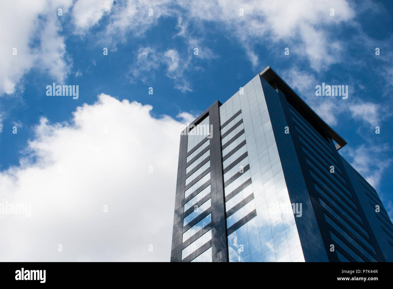 Business building windows made of glass reflects the blue color of the ...