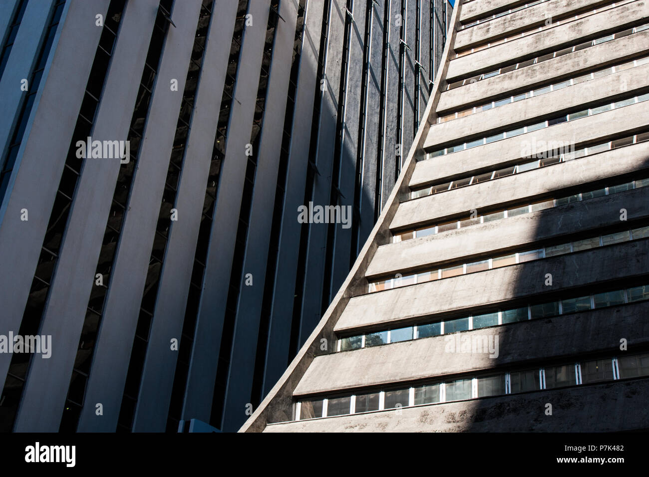Rounded corporate concrete building detail view with shadows on the ...