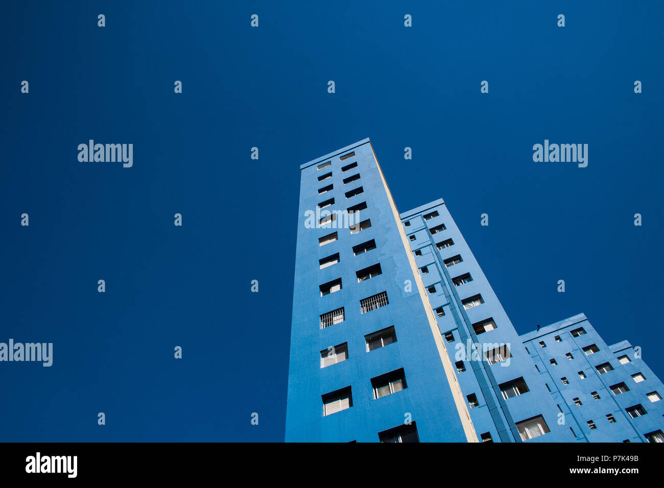 Blue lonely home building with clear blue sky background Stock Photo - Alamy