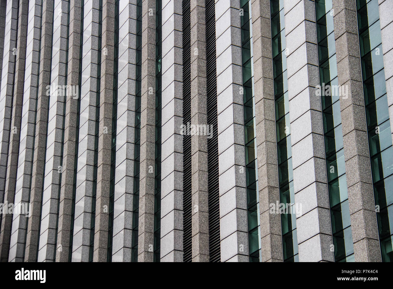 View of a business building made of concrete columns and glass mirror ...
