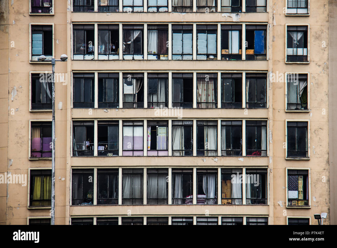Front high view of houses in a concrete yellow building Stock Photo - Alamy