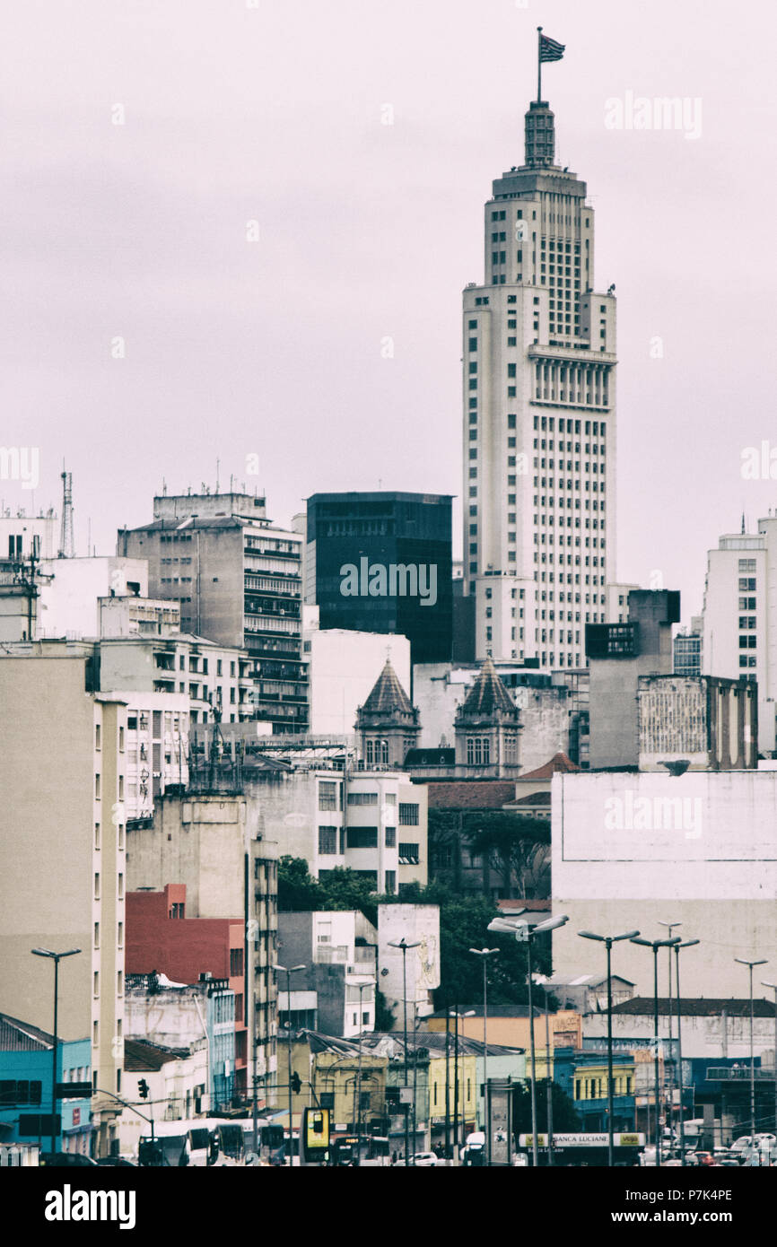 A huge white tower among business and residential buildings whit white ...