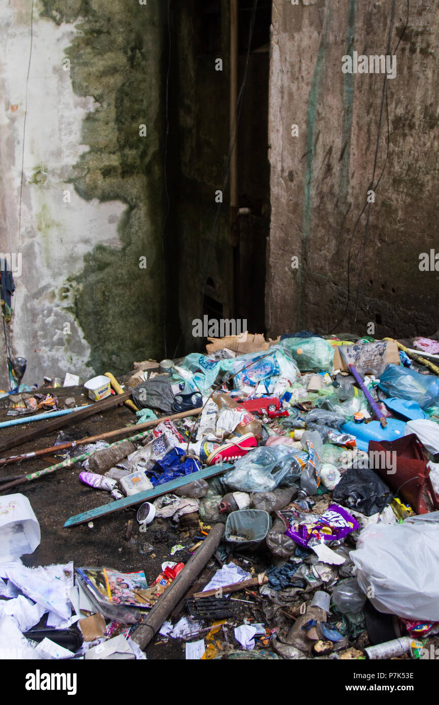 Trash in an occupied residential building near a dangerous deep empty ...
