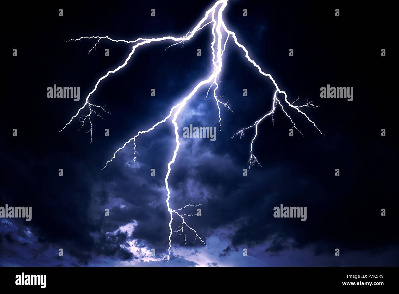 A lightning strike on a cloudy dramatic stormy sky Stock Photo - Alamy