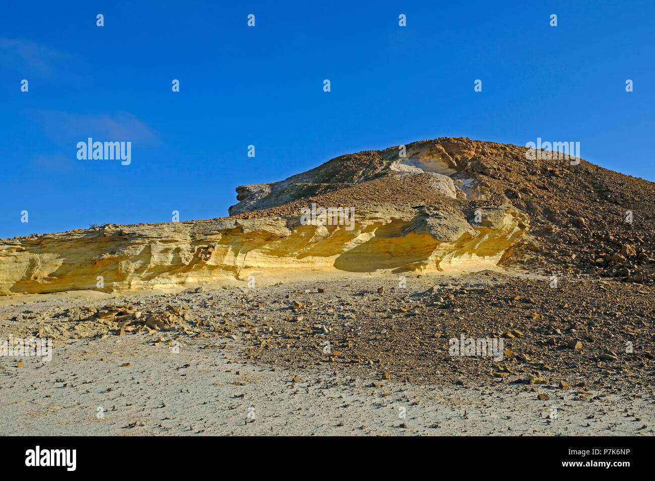 Broken flank of a sandstone hill with clean, sharp-edged failure plane ...