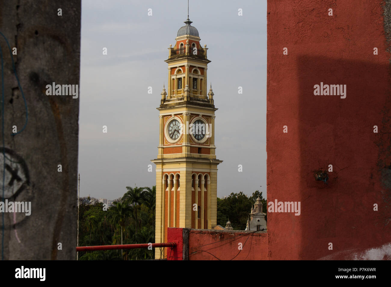 Classical architectural clock tower seen from behind cracked red and ...