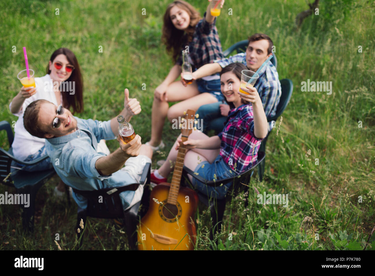 Group of friends having picnic in park Stock Photo - Alamy