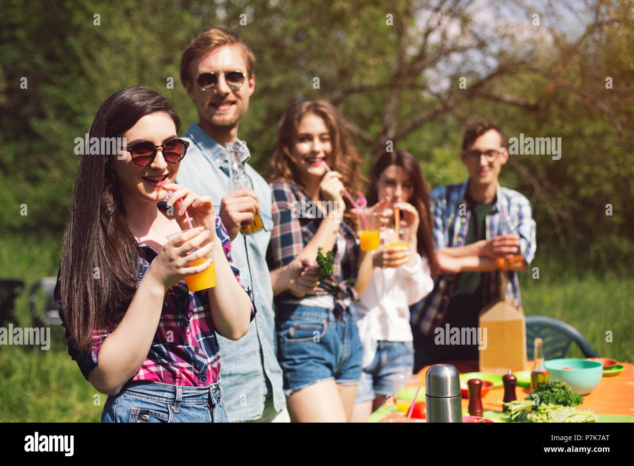 Group of friends having picnic in park Stock Photo - Alamy