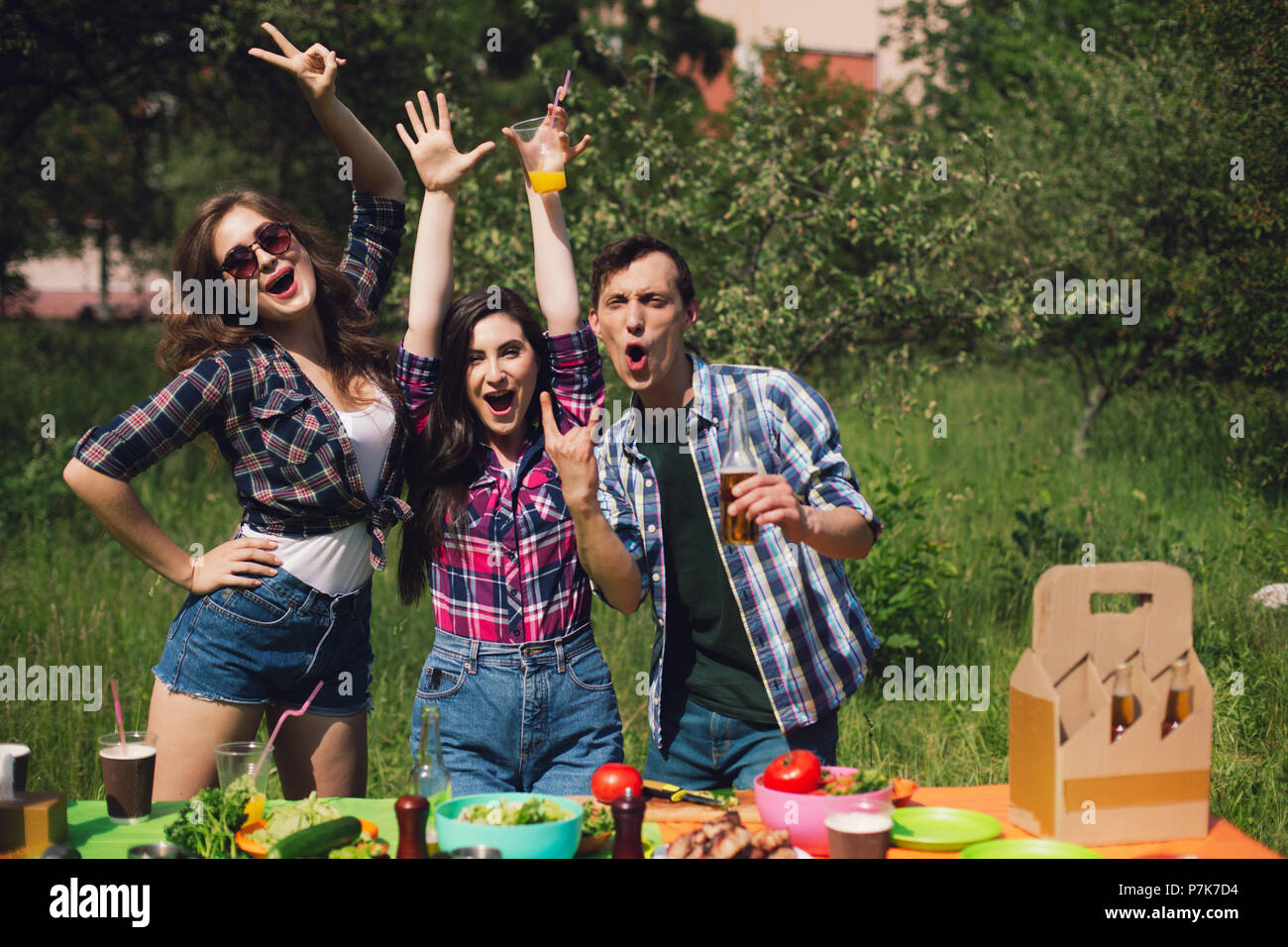 Group of friends having picnic in park Stock Photo - Alamy