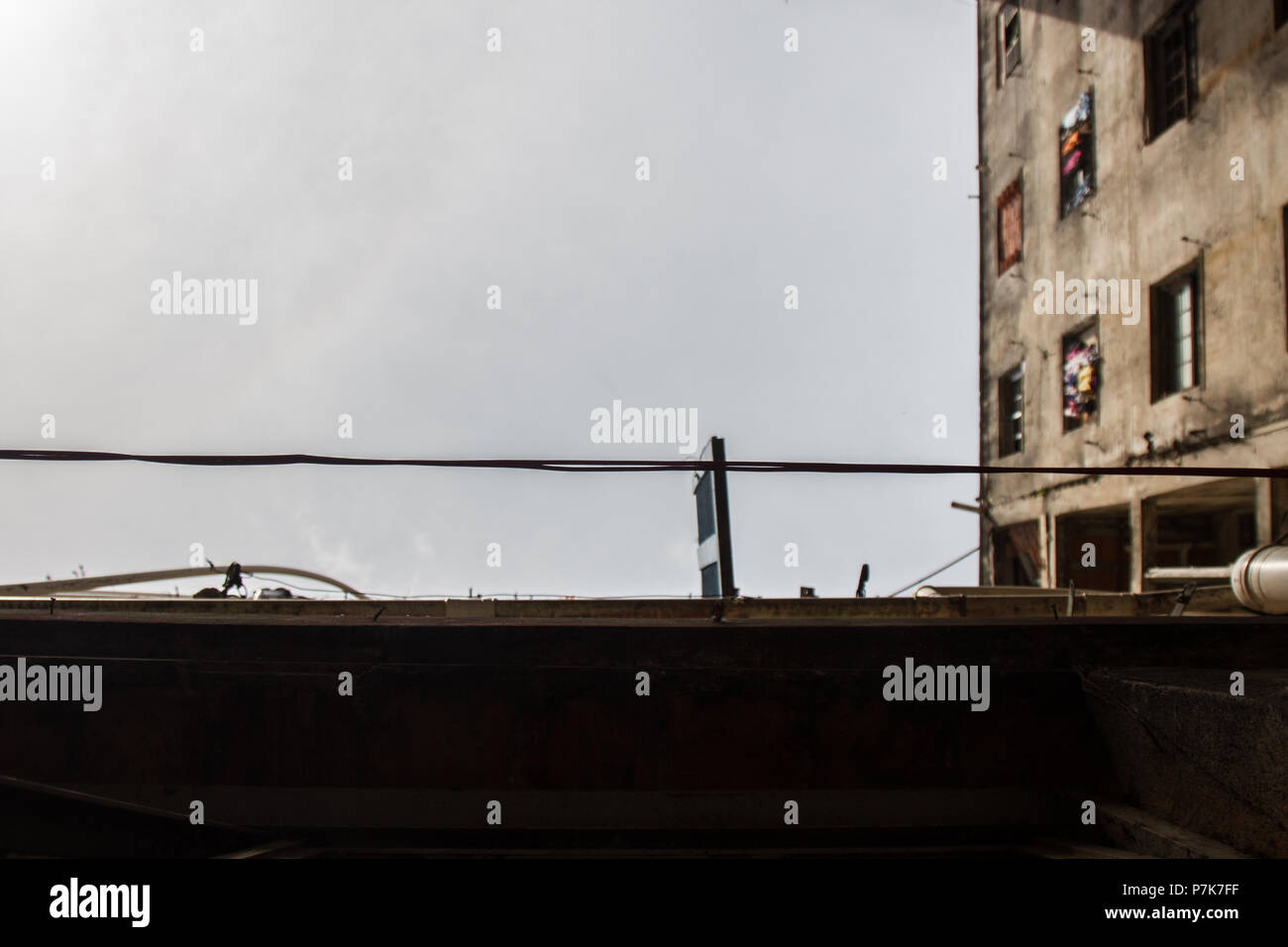Low angle view of an open window blind of an abandoned ruined building ...