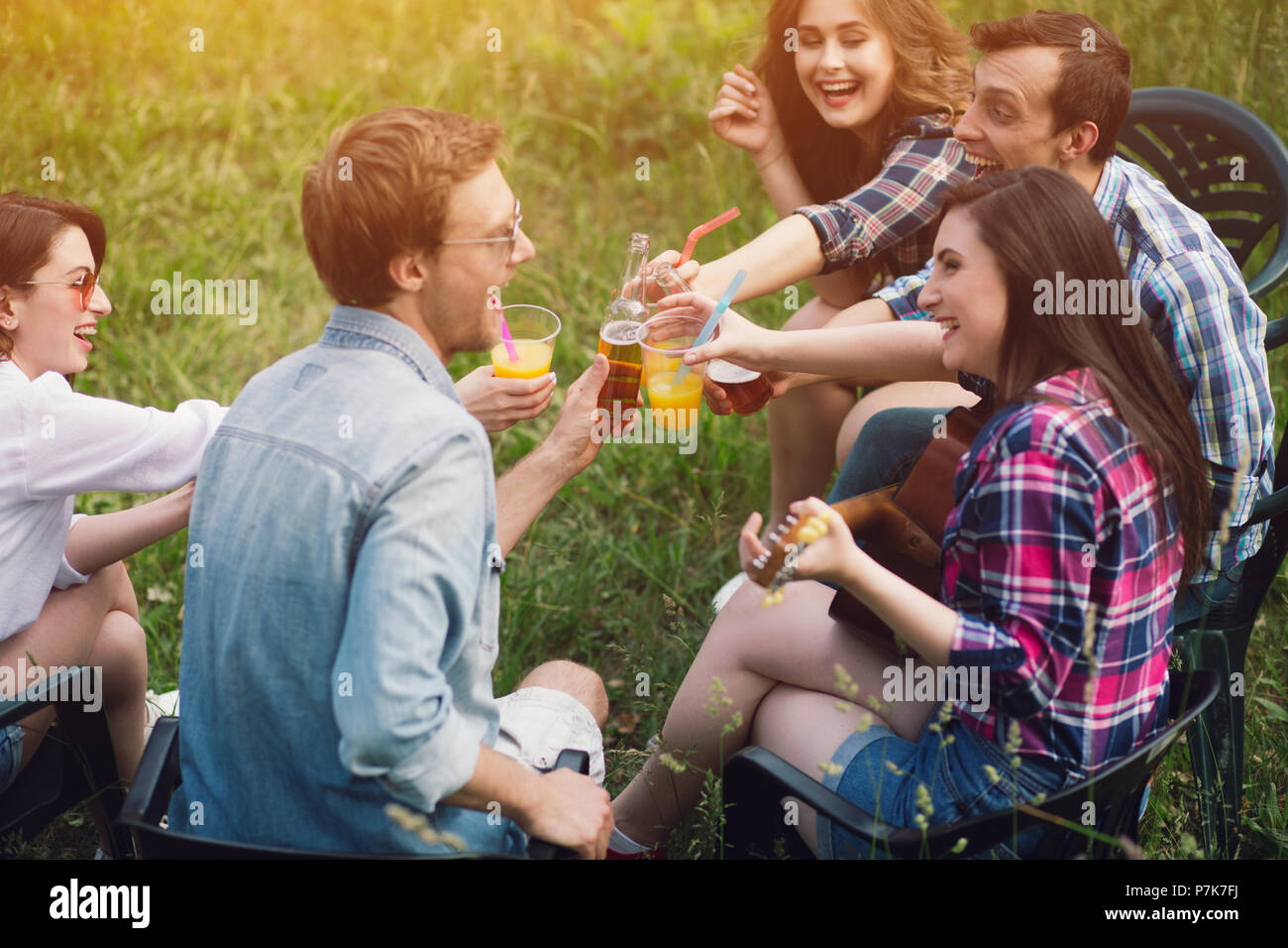 Group of friends having picnic in park Stock Photo - Alamy