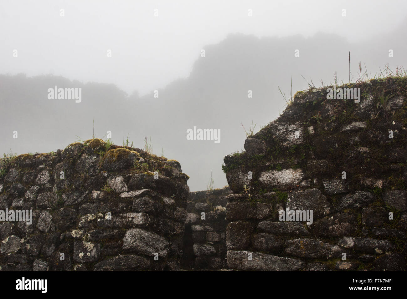Historical ruins of the ancient Inca civilization covered by fog at ...