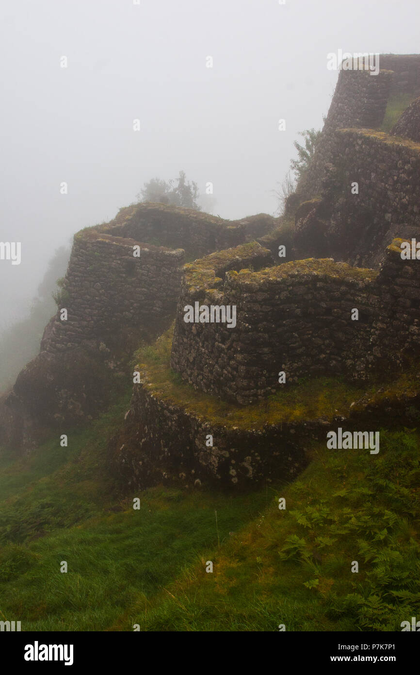Historical ruins of the ancient Inca civilization covered by fog at ...