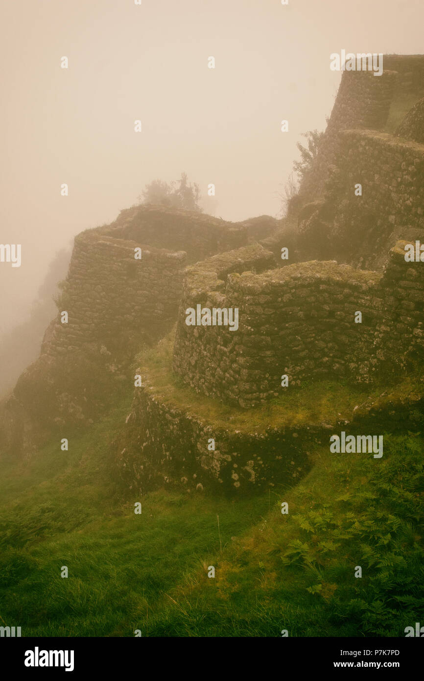 Historical ruins of the ancient Inca civilization covered by fog at ...