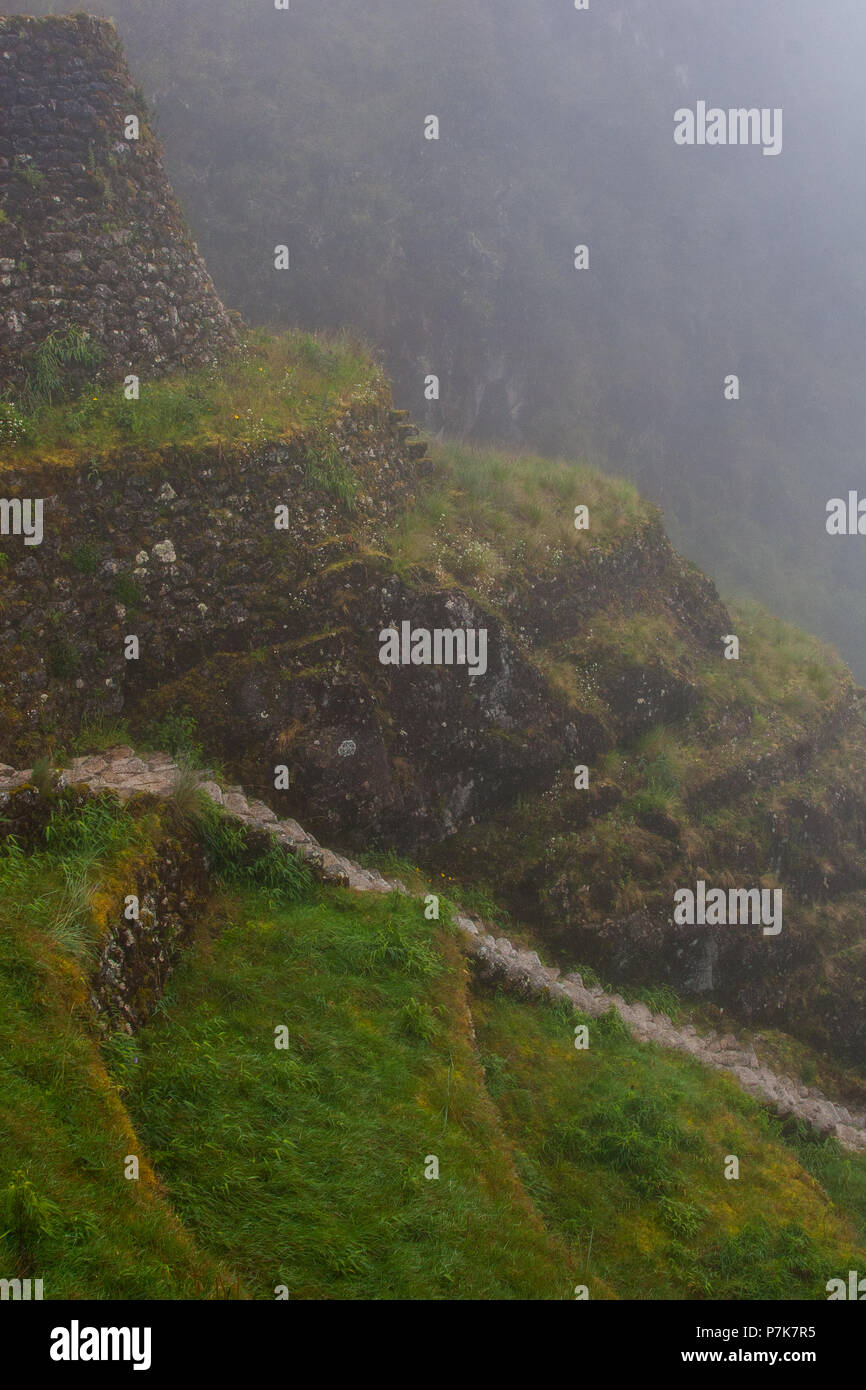Historical ruins of the ancient Inca civilization covered by fog at ...