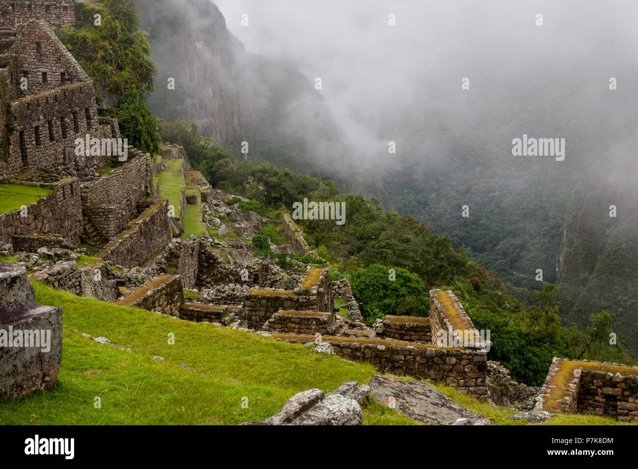 Ruins of Machu Picchu on a cliff in the Andes mountains with fog. Peru ...