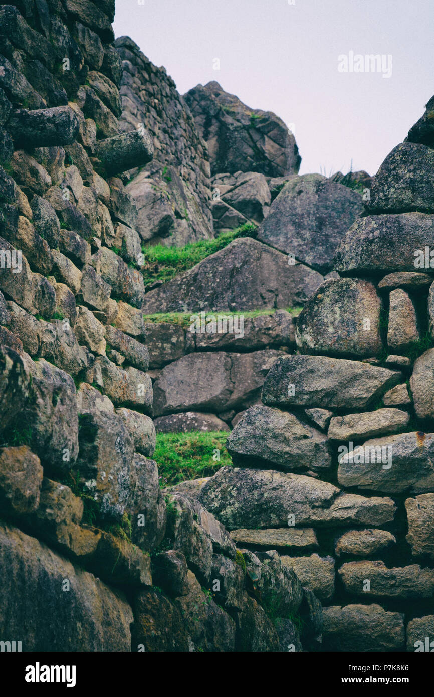 Stone magical ancient ruins along the paved path Inca Trail to Machu ...