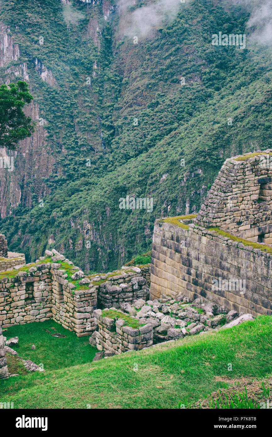 Vertical viiew of ruins of Machu Picchu Inca culture on a cliff in the ...
