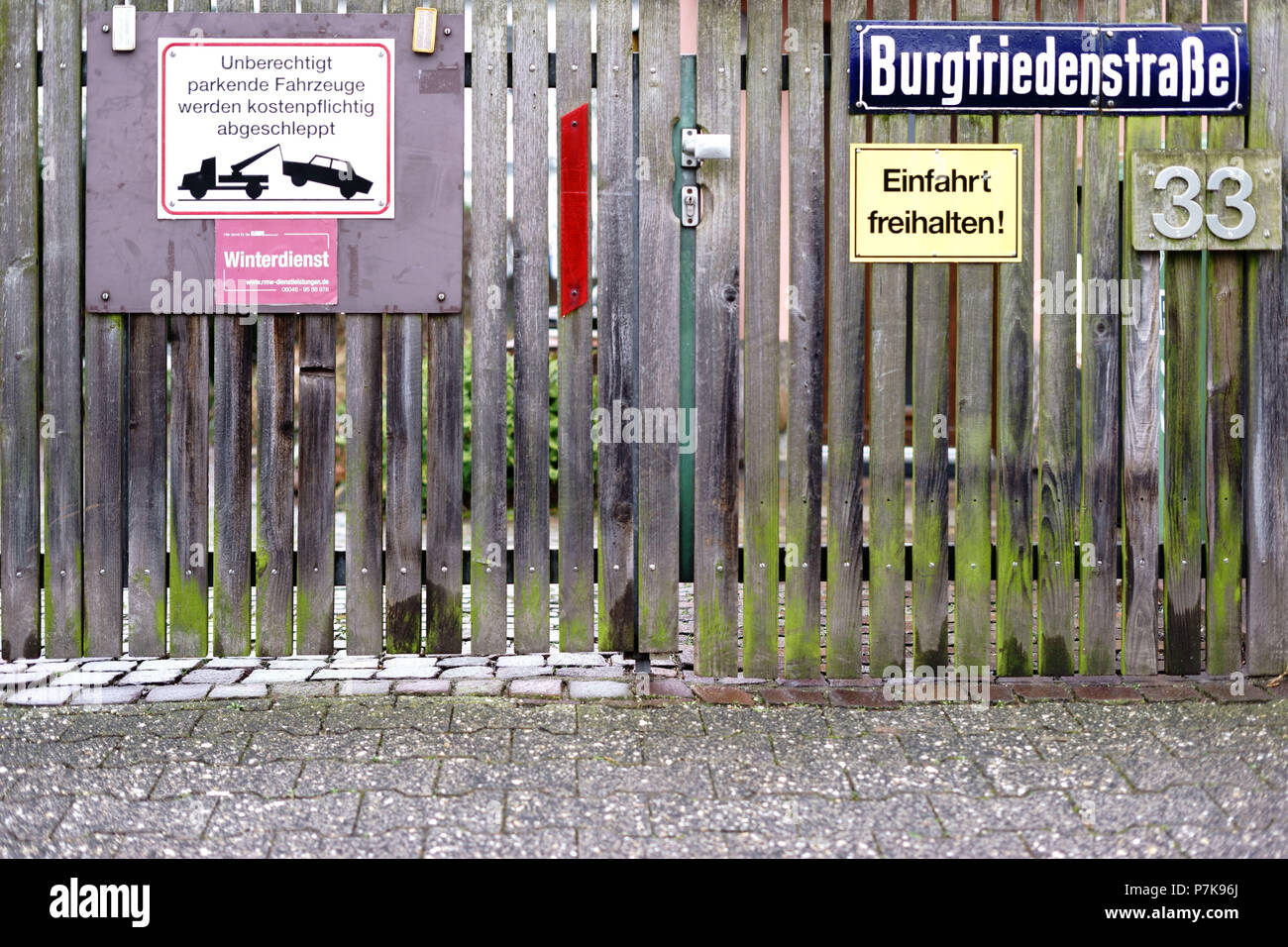 Many different traffic signs on the wooden fence of a driveway Stock ...