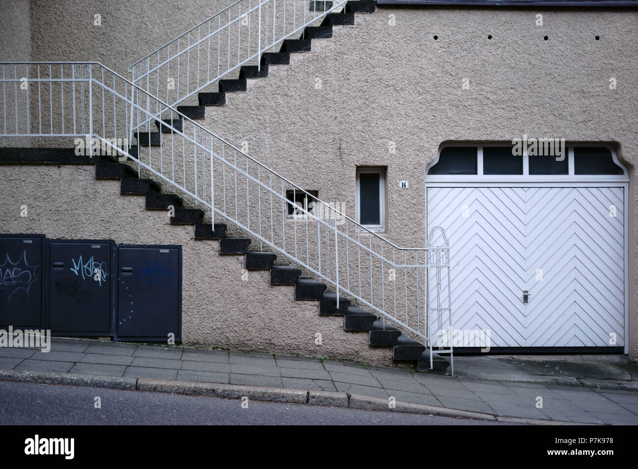 Side view of a sloping staircase next to a garage on a steep mountain ...