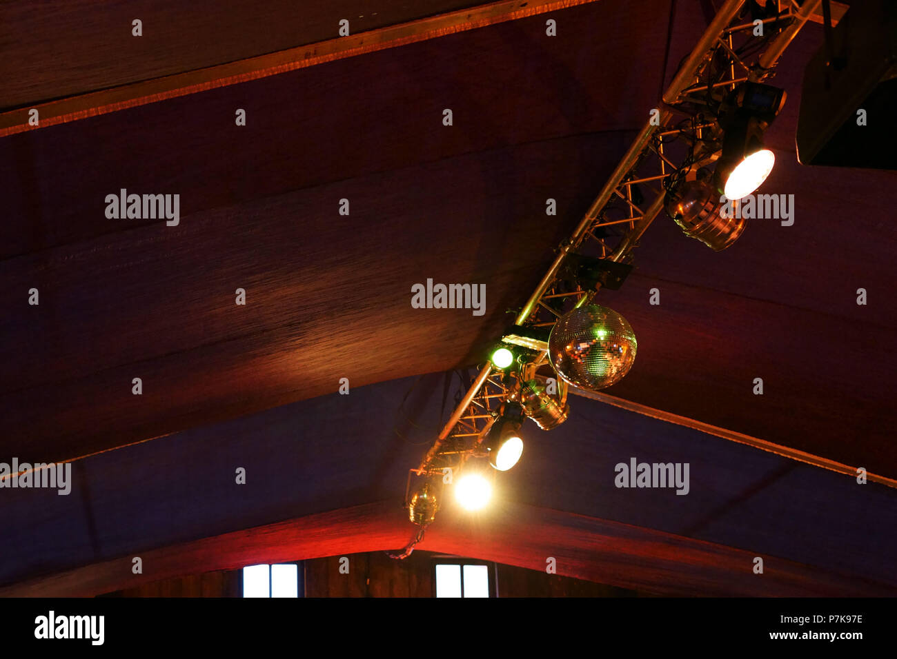 A lighting system with disco lights, light spots and a disco ball under ...