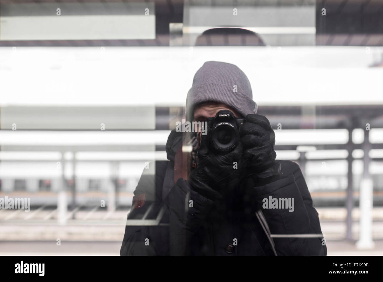 Self portrait in the windowpane of a train Stock Photo - Alamy