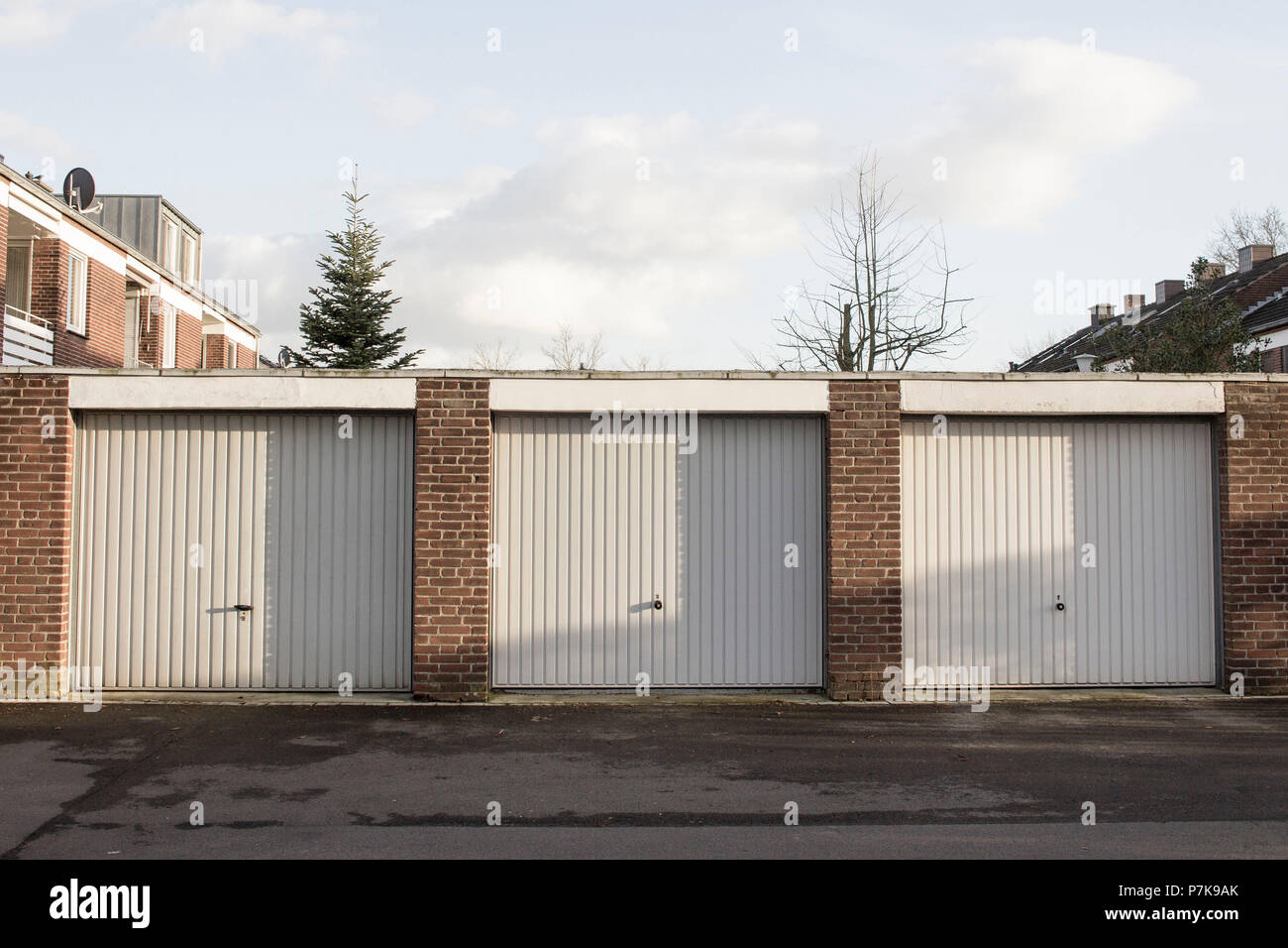 Three garages in a terraced housing estate Stock Photo - Alamy