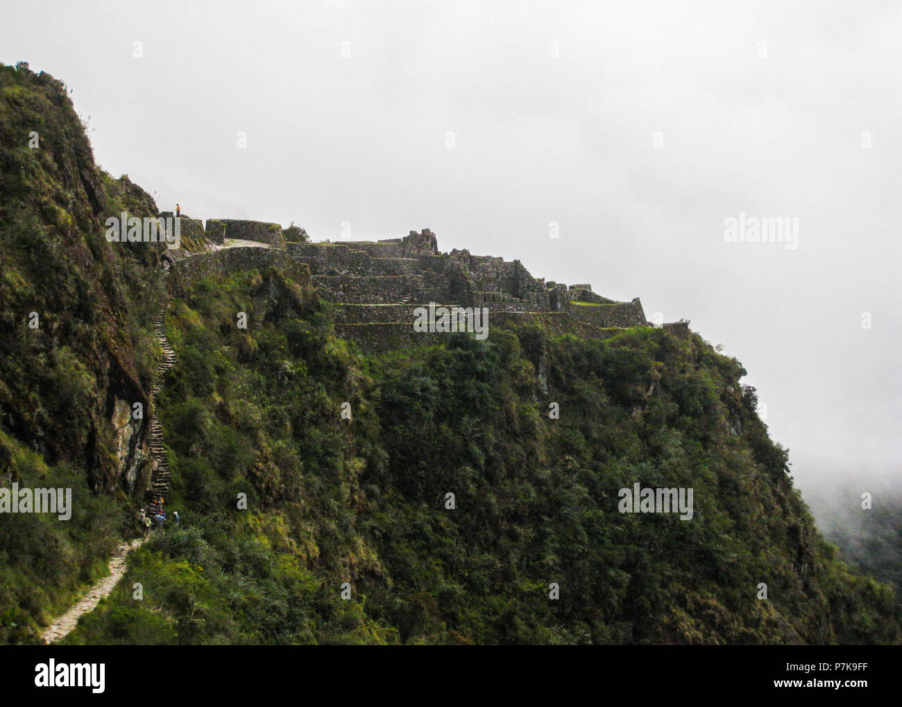 Ancient Inca Trail paved path to the lost city of Machu Picchu. Peru ...