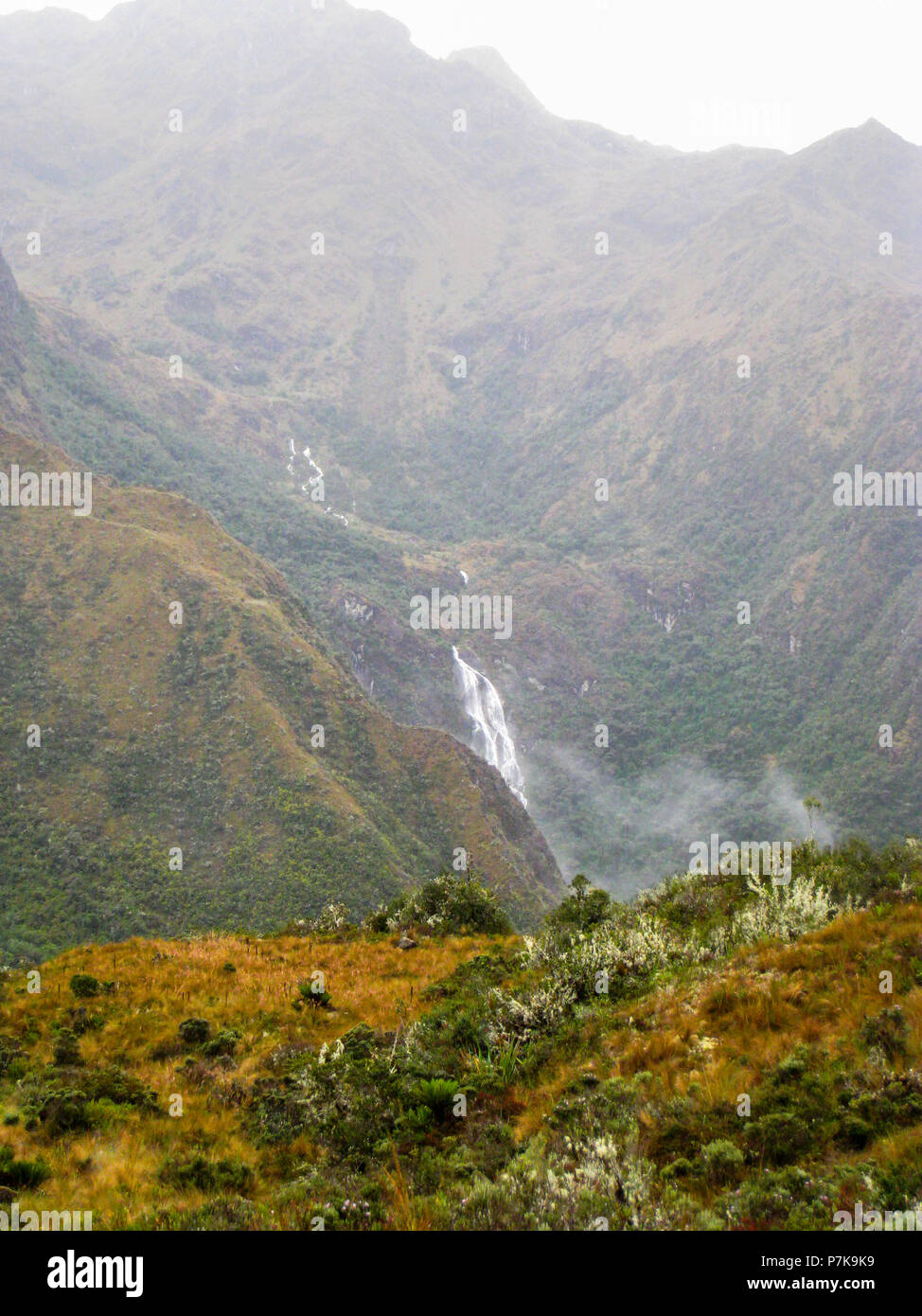 Vertical photo of a waterfall on the Andes mountains with fog. Peru ...
