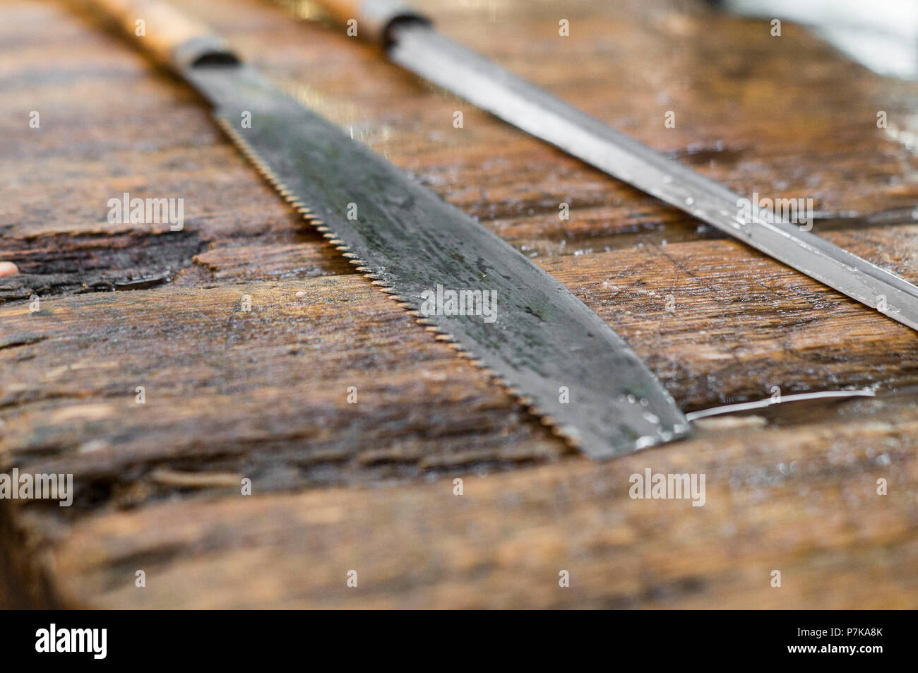 A Japanese balde of a knife on a workbench at the fish market Tokyo ...