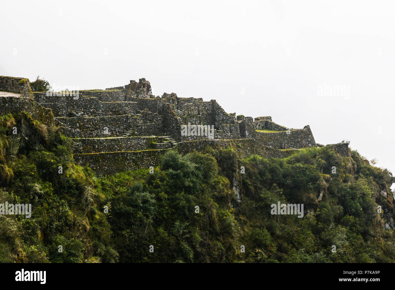 Historical lost ancient Inca stone ruins on a cliff with wild nature ...