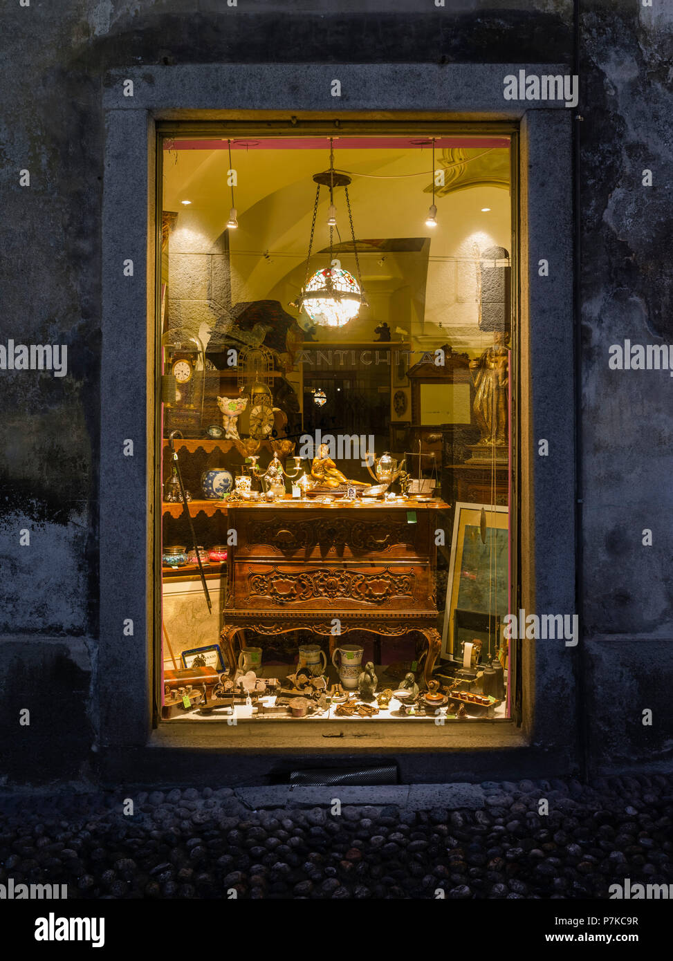 Illuminated window of an antique shop in the historic center of Locarno ...