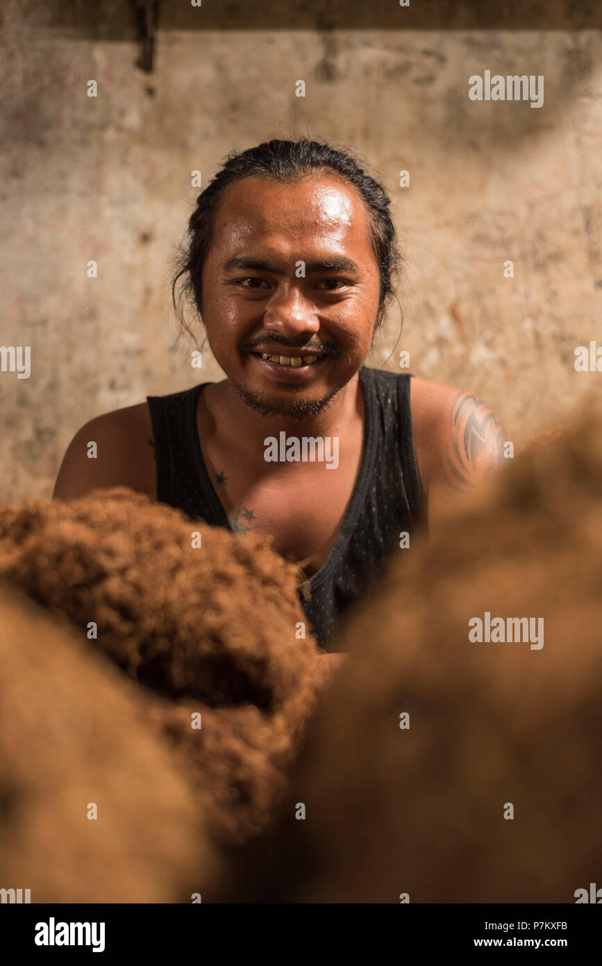 The tobacconist of Kutacane smoking behind his tobacco Stock Photo - Alamy