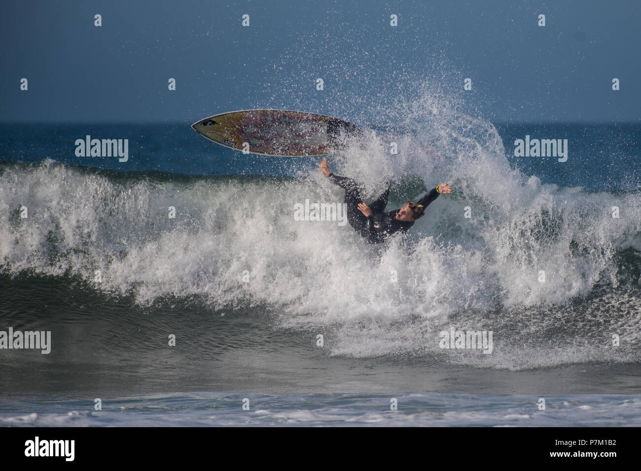 Young California surfer falling off the wave as his board goes flying ...