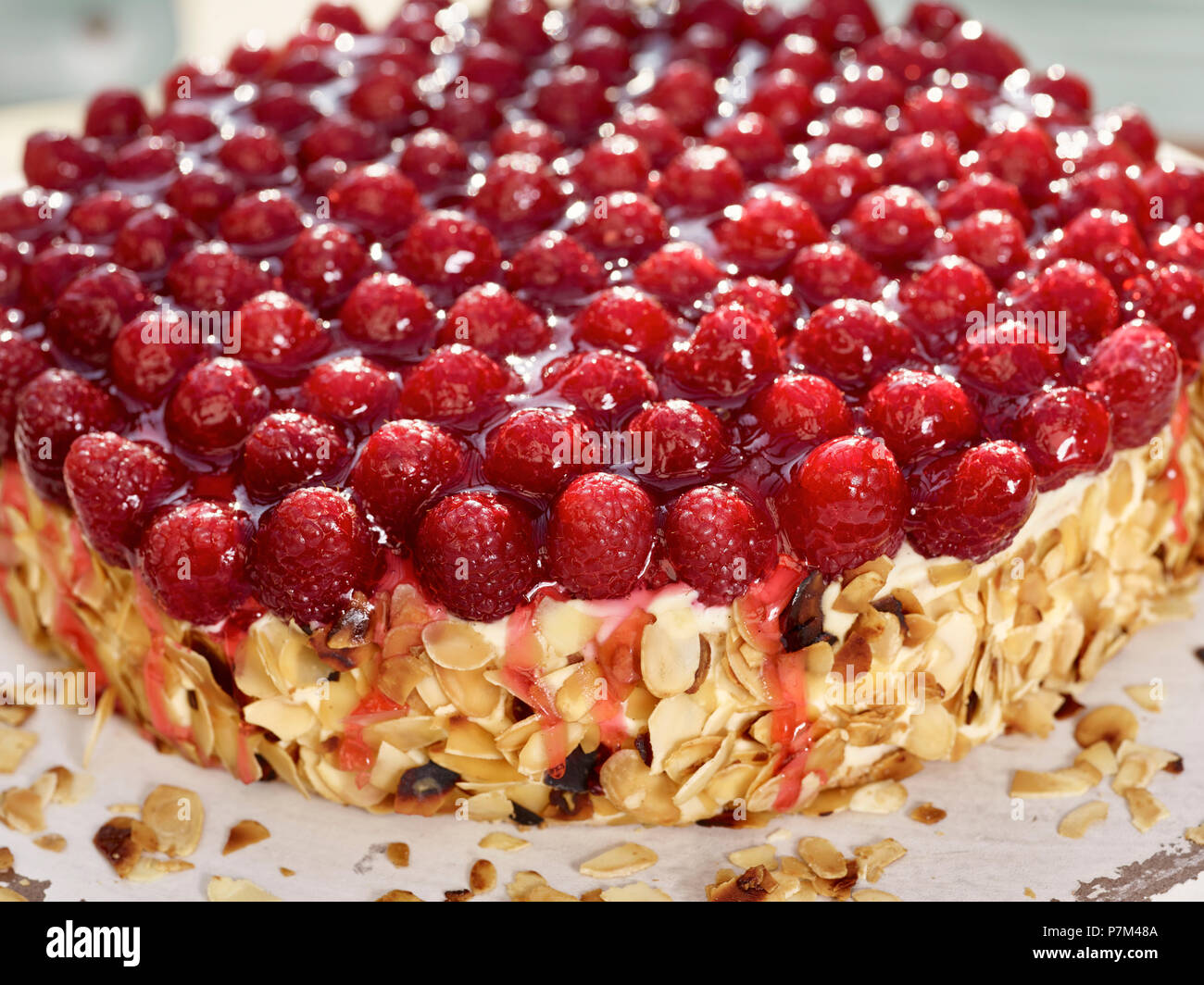 Steps to make a raspberry cake, spreading icing on the cake Stock Photo ...