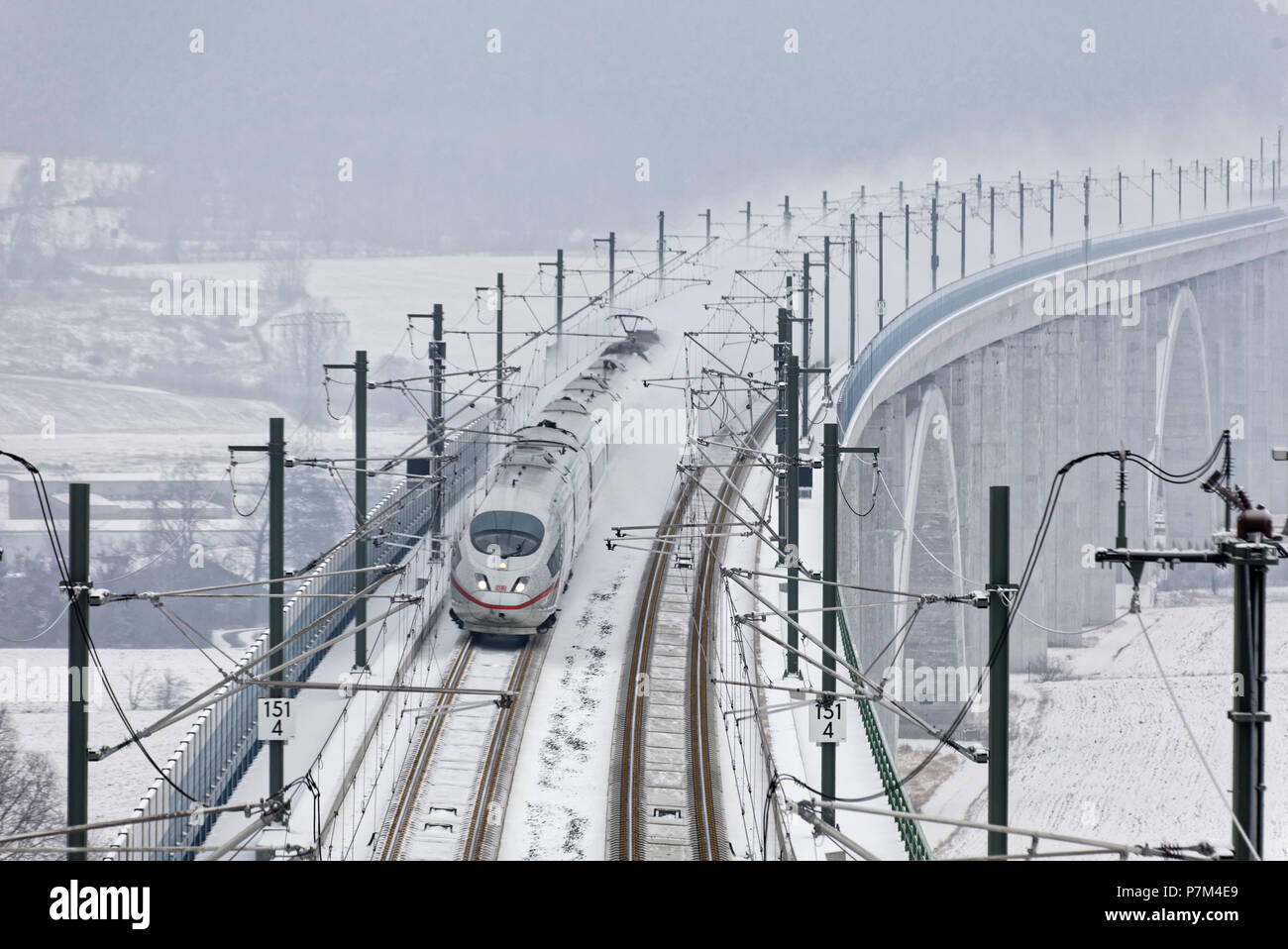 Train, bridge, overhead line, snow Stock Photo - Alamy