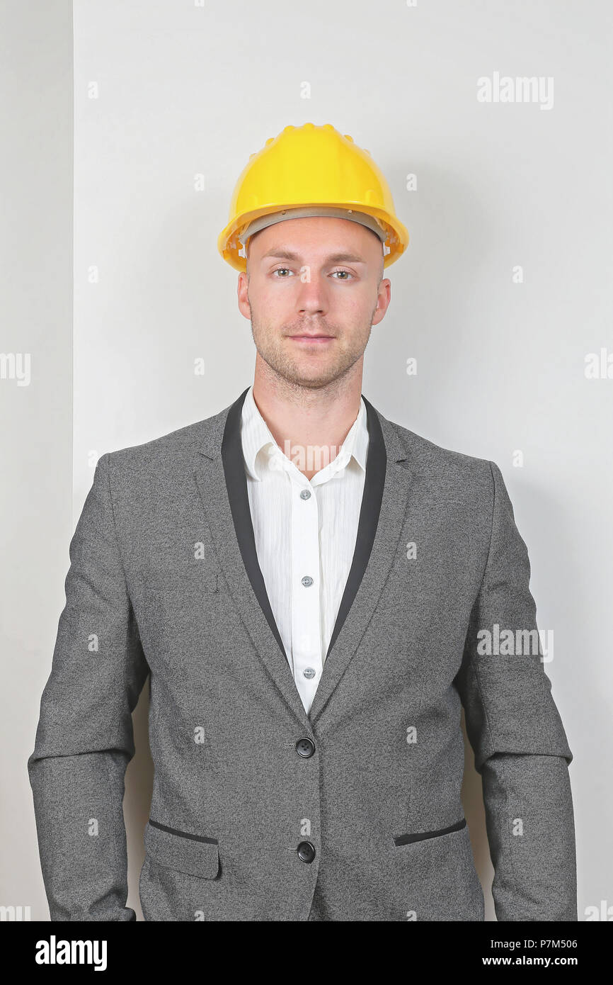 Young Businessman in Gray Suit with Yellow Hard Hat Stock Photo - Alamy