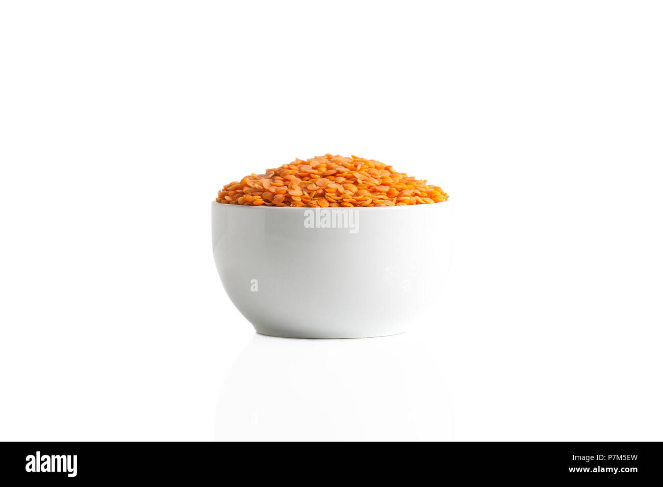 Stack of red lentils in a cup isolated on a white background Stock ...