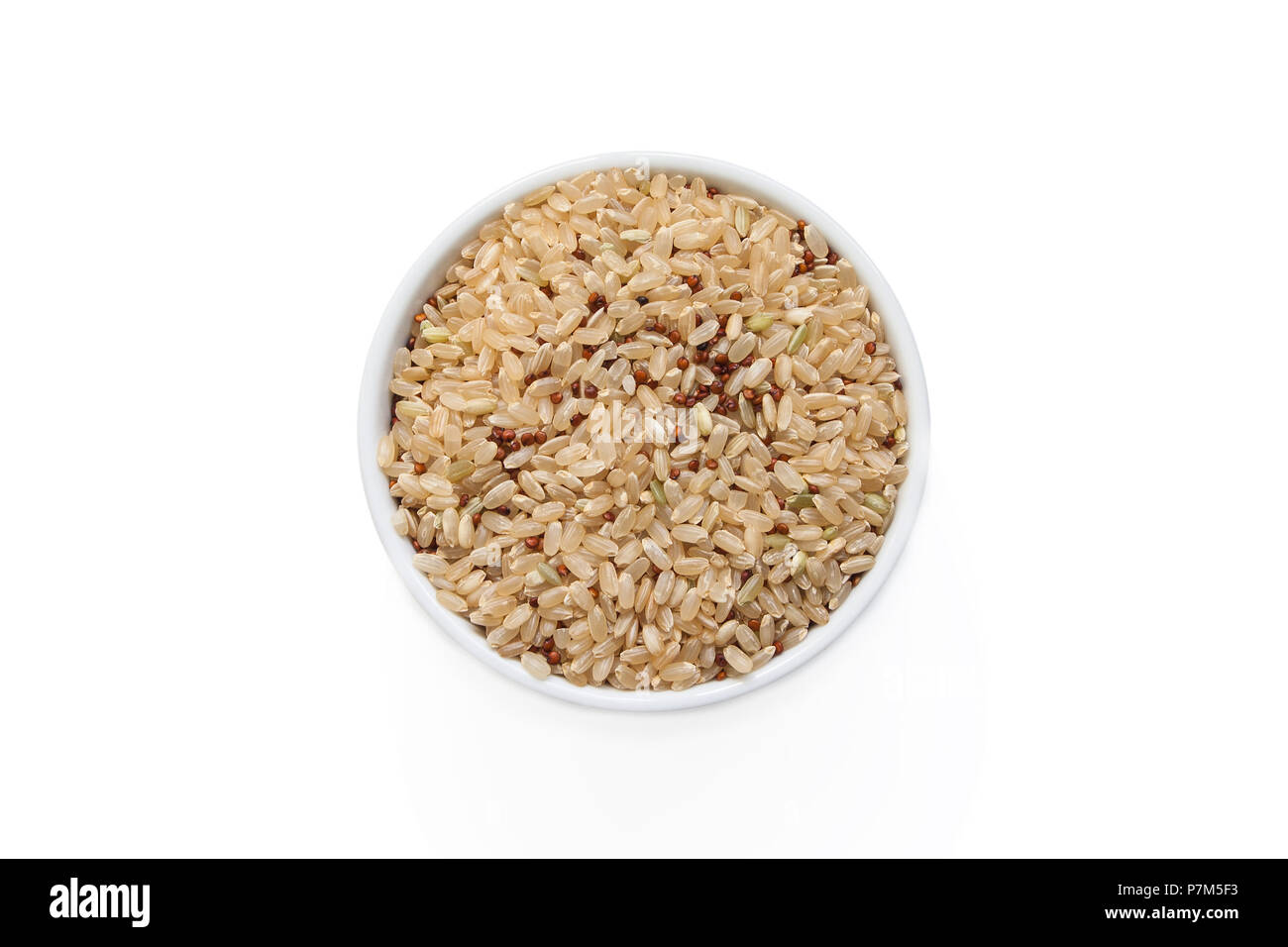 Quinoa and brown rice in a cup from above isolated on a white ...