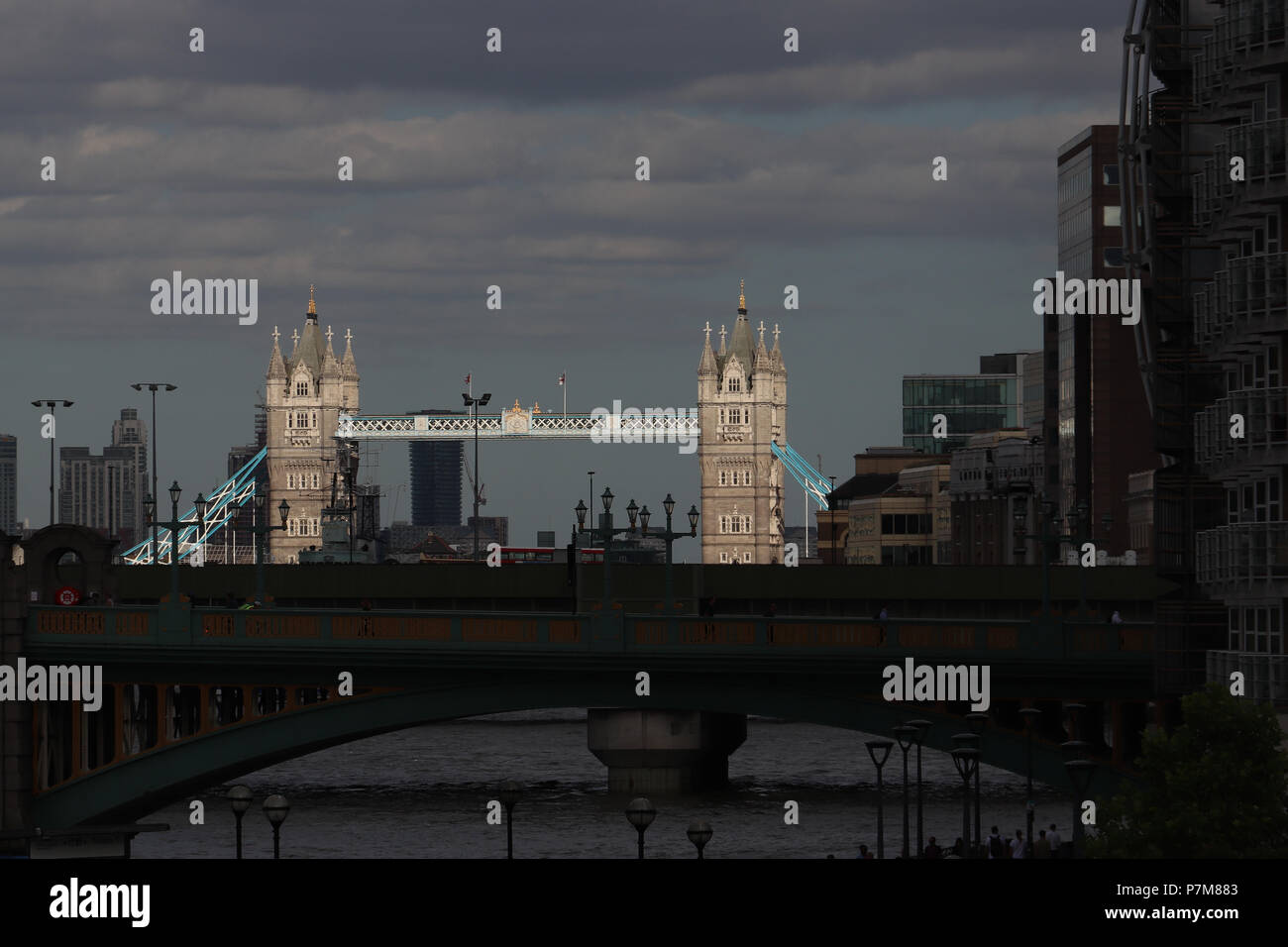 View down the Thames River on a cloudy evening, the London Bridge in ...