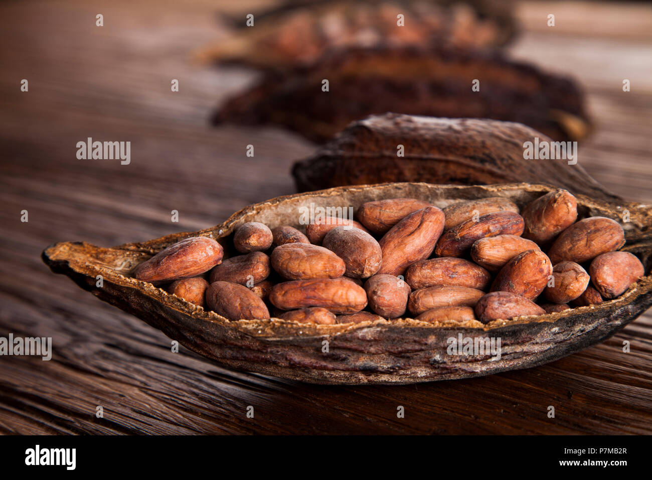 Cocoa pod on wooden background Stock Photo - Alamy