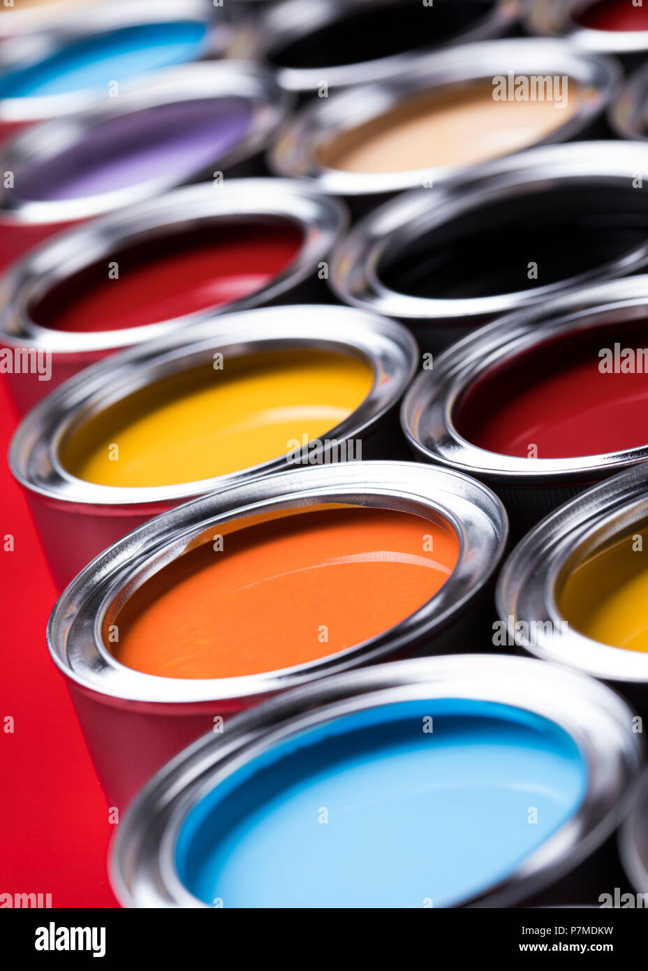 Group of tin metal cans with color paint Stock Photo - Alamy