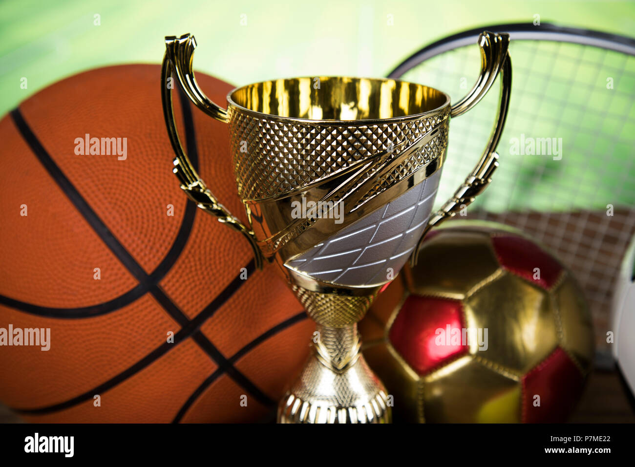 Cups of winners award, Sport equipment and balls Stock Photo - Alamy