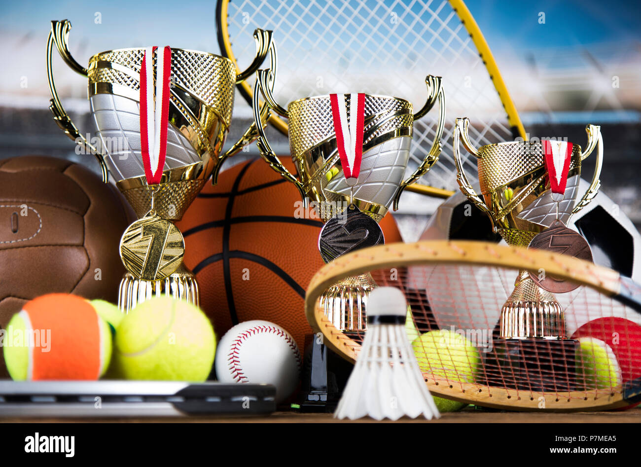 Cups of winners award, Sport equipment and balls Stock Photo - Alamy