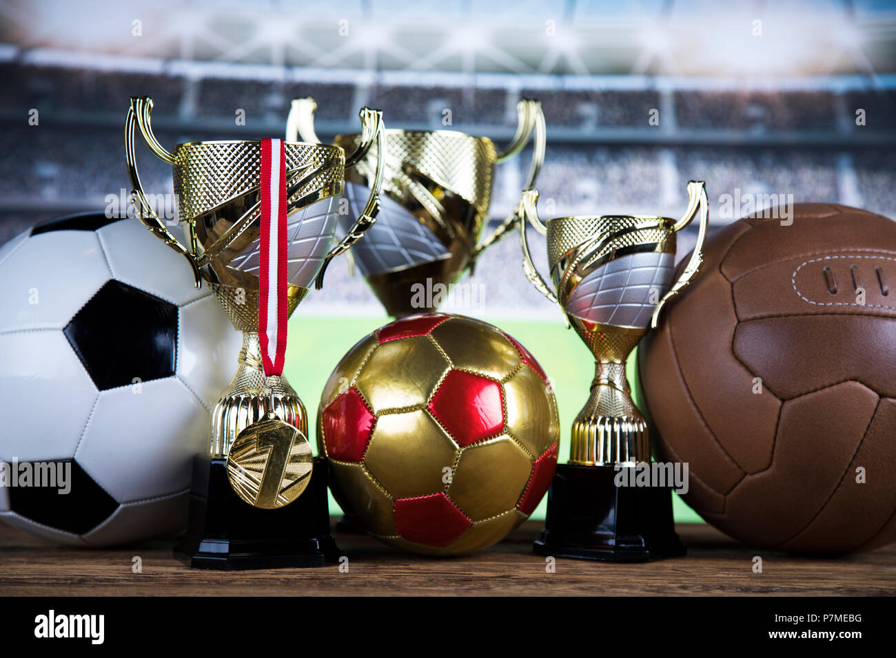 Cups of winners award, Sport equipment and balls Stock Photo - Alamy